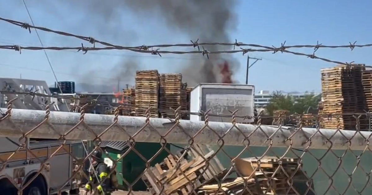 Pallet fire extinguished near light rail tracks in Denver - CBS Colorado