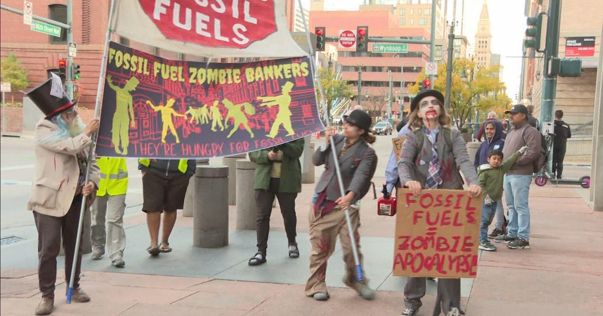 Climate activists roam Denver dressed as zombies to protest fossil fuel ...