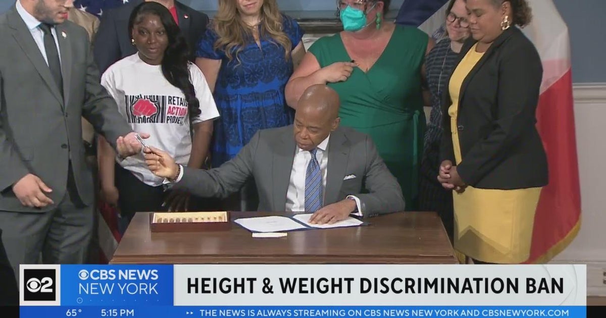 Adams signs height, weight discrimination ban into law - CBS New York