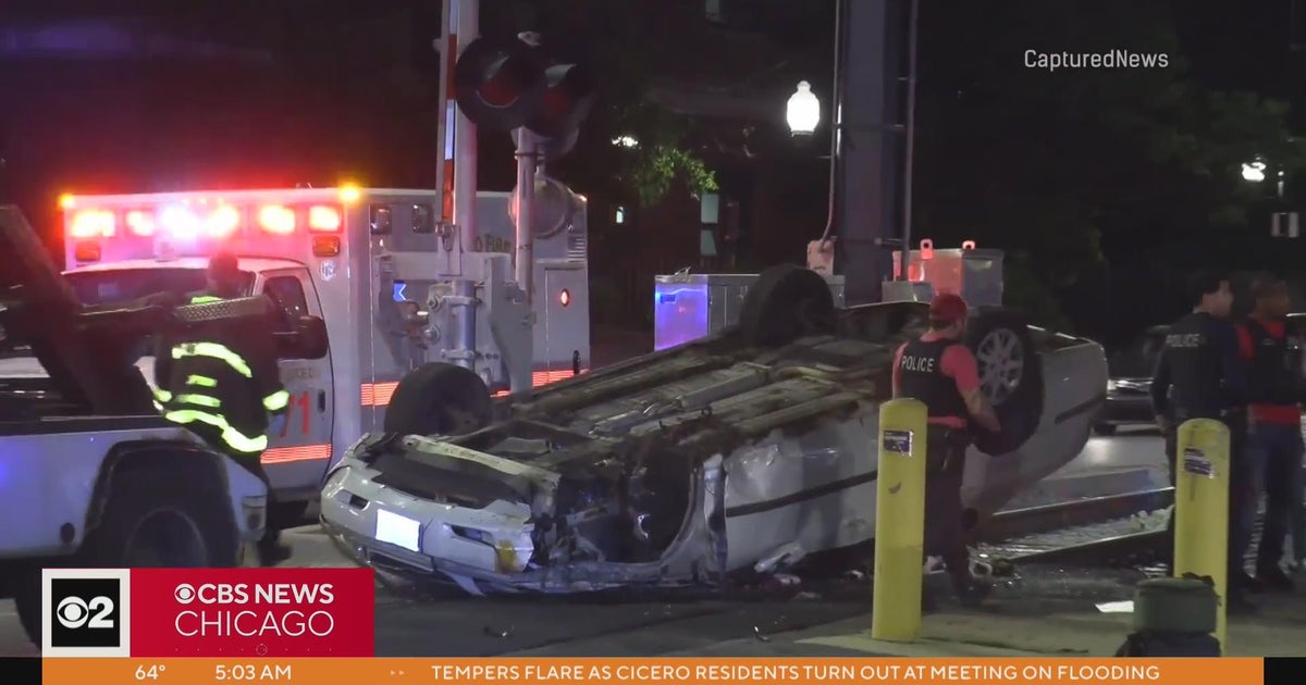 Car hits pole, flips over on Metra tracks in South Shore - CBS Chicago