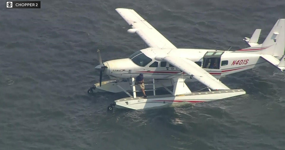 See It: Pilot and co-pilot rescued from seaplane in East River - CBS ...