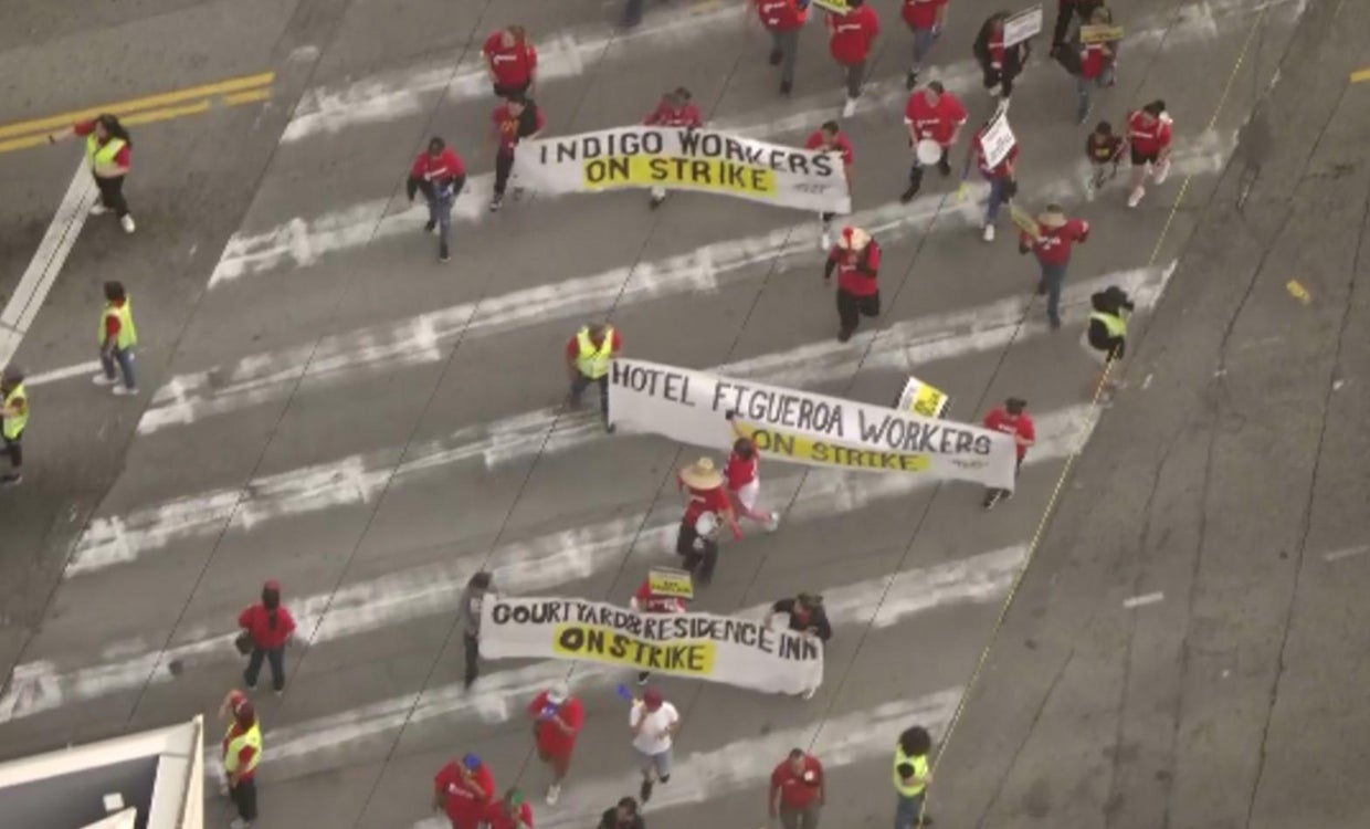 Hotel workers walk off the job and march through downtown LA amid ...