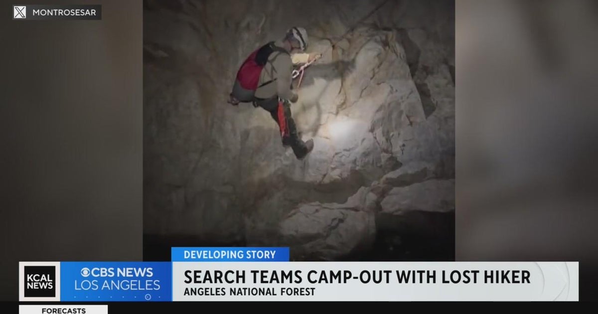 Search and rescue teams camp out with lost hiker before lifting him to ...