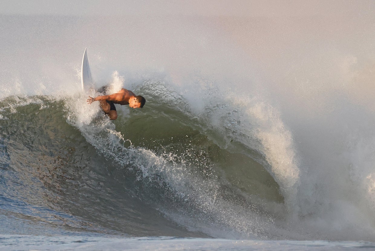 "It's really dangerous": Surfers face "chaotic" waves and storm surge ...