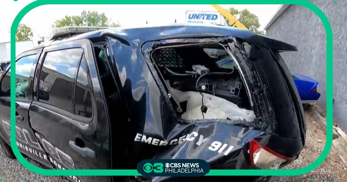 Distracted driver hits police officer's SUV while he's inside - CBS ...