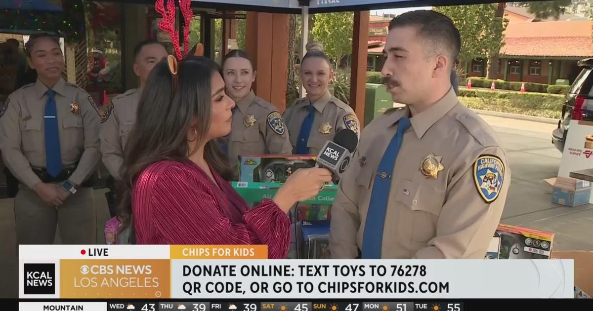 Officer Alec Pereyda helps with the CHiPs for Kids Knott’s Berry Farm ...