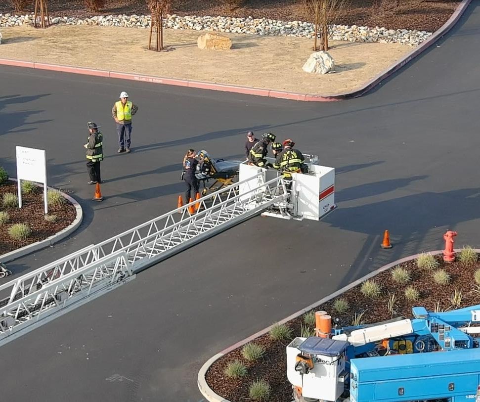 Firefighters rescue 2 workers stuck on boom lift next to high-voltage ...