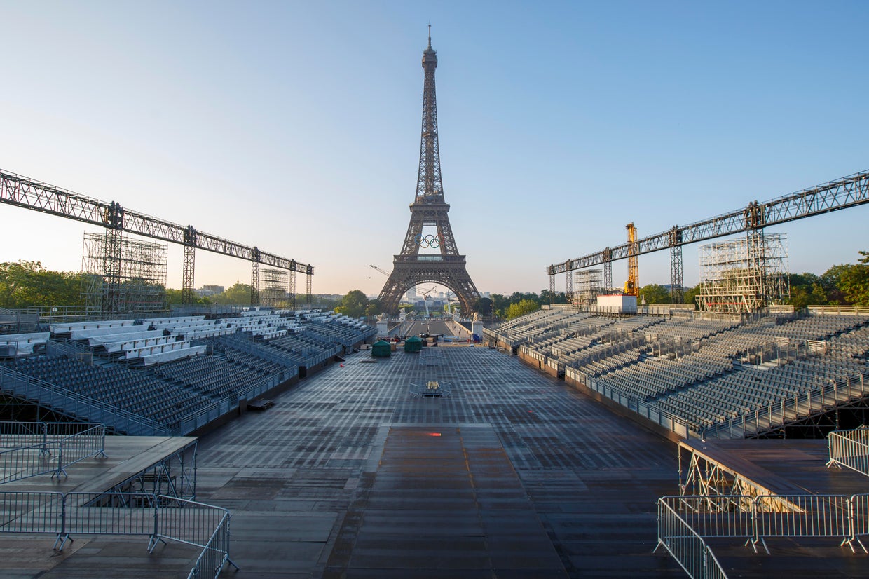 Olympic rings mounted on the Eiffel Tower ahead of Summer Games - CBS News