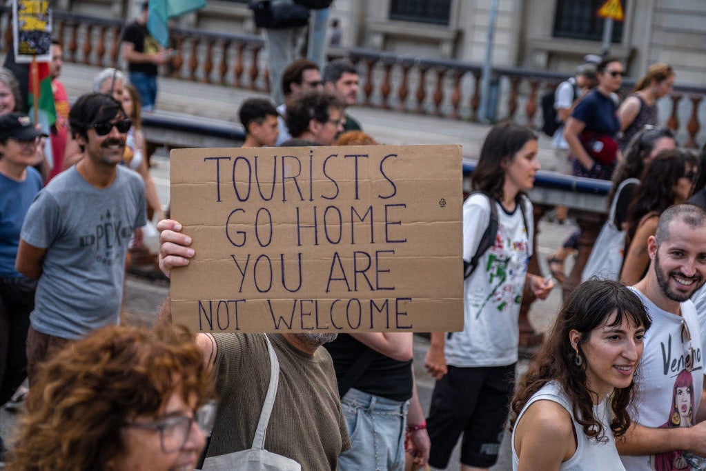 Spanish anti-tourism protesters take aim at Barcelona visitors with ...