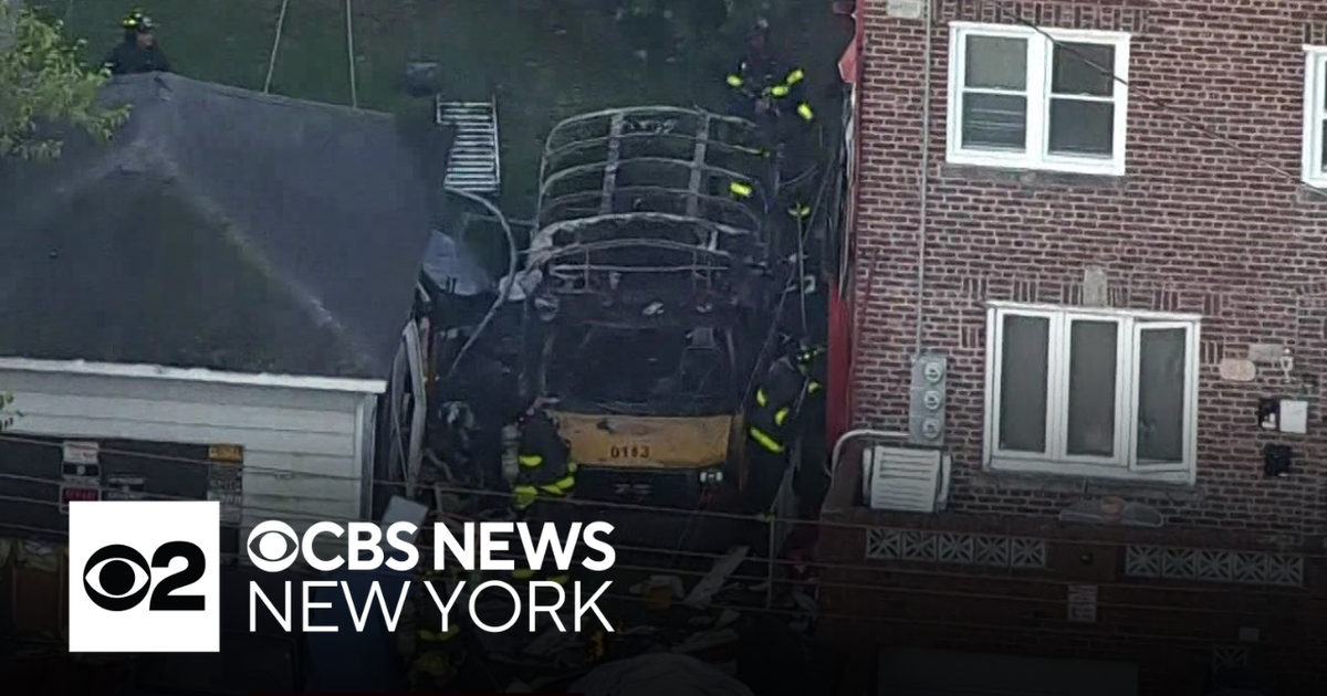 School bus catches fire between Brooklyn buildings - CBS New York