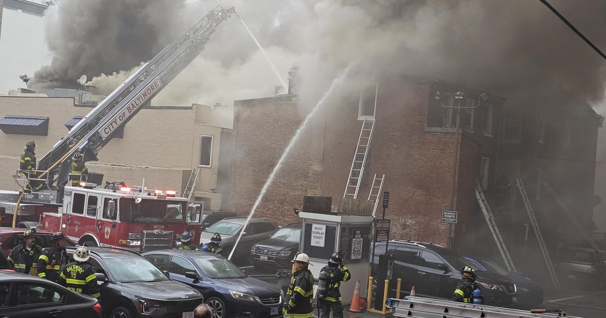 Baltimore City Fire officials battle a 5 alarm building fire Sunday ...