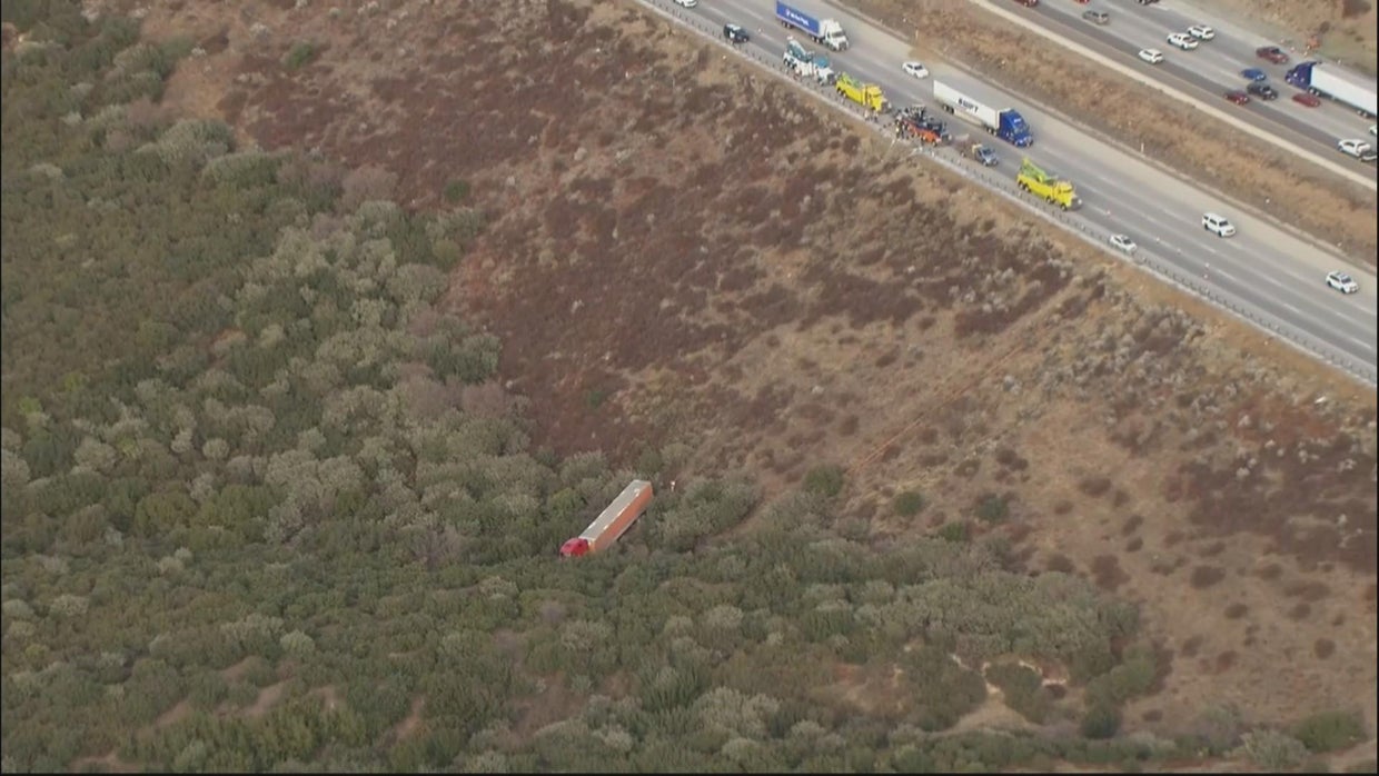 Big rig rolls down hillside after crashing into divider on I-15 Freeway ...