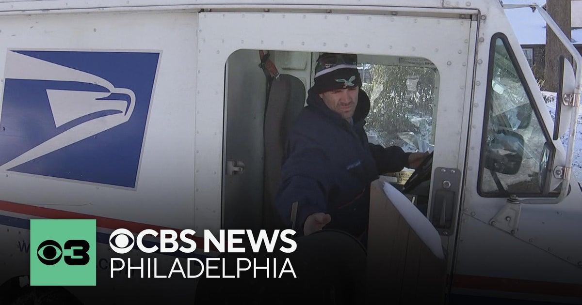 USPS letter carrier on his route in Huntingdon Valley, Pennsylvania ...
