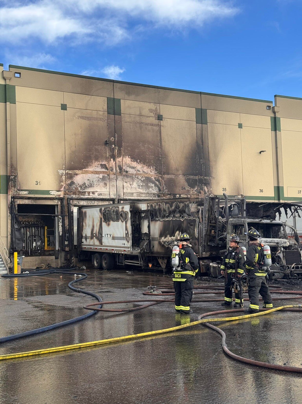 Two-alarm fire damages building, several semi trucks in Aurora ...