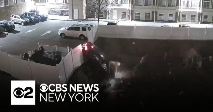 Car left teetering on retaining wall after crashing through fence in ...