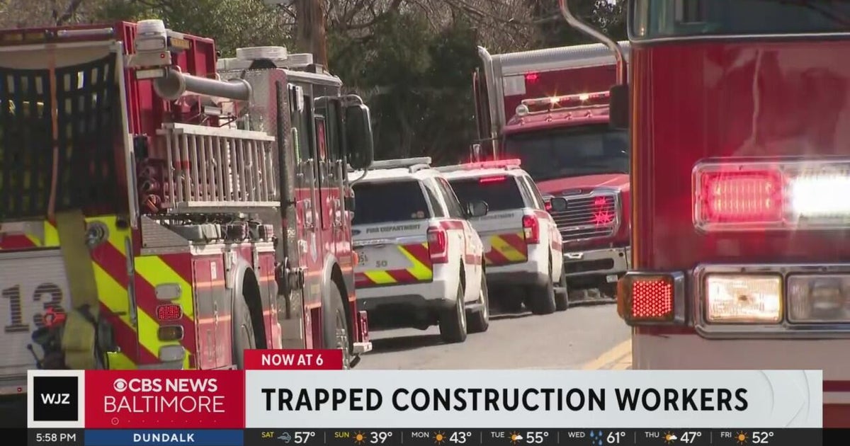 Crews trying to rescue two construction workers trapped in collapsed ...