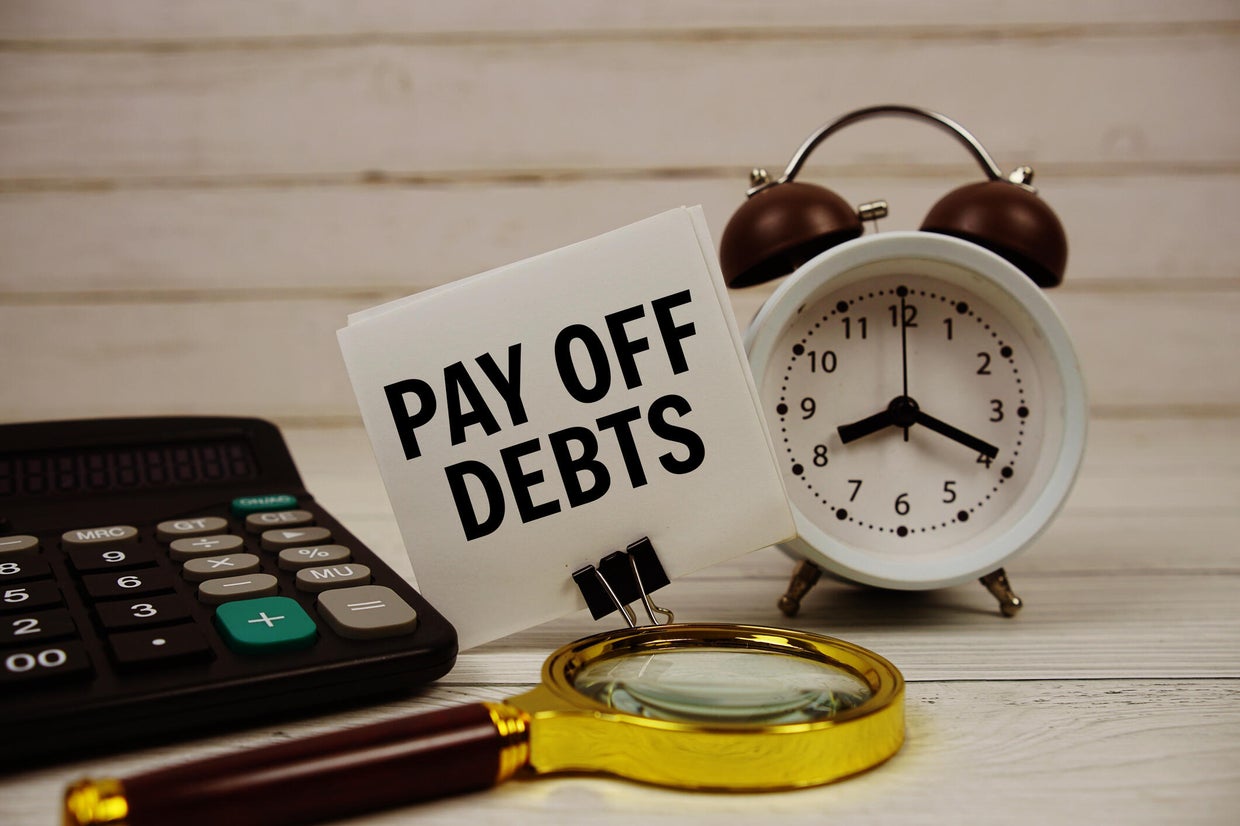 What happens if you stop paying a debt relief company? - CBS News