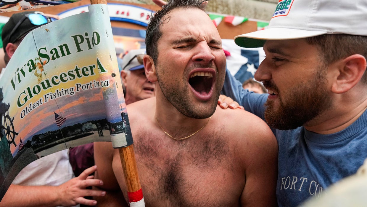 The greasy pole contest at St. Peter's Fiesta in Gloucester starts ...