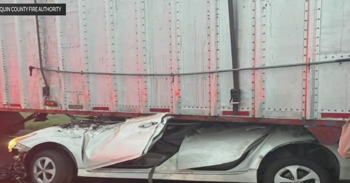 Driver escapes with minor injuries after car lodged under big rig ...